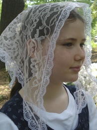 A young Korean Catholic lady in a pure white flowered mantilla ...